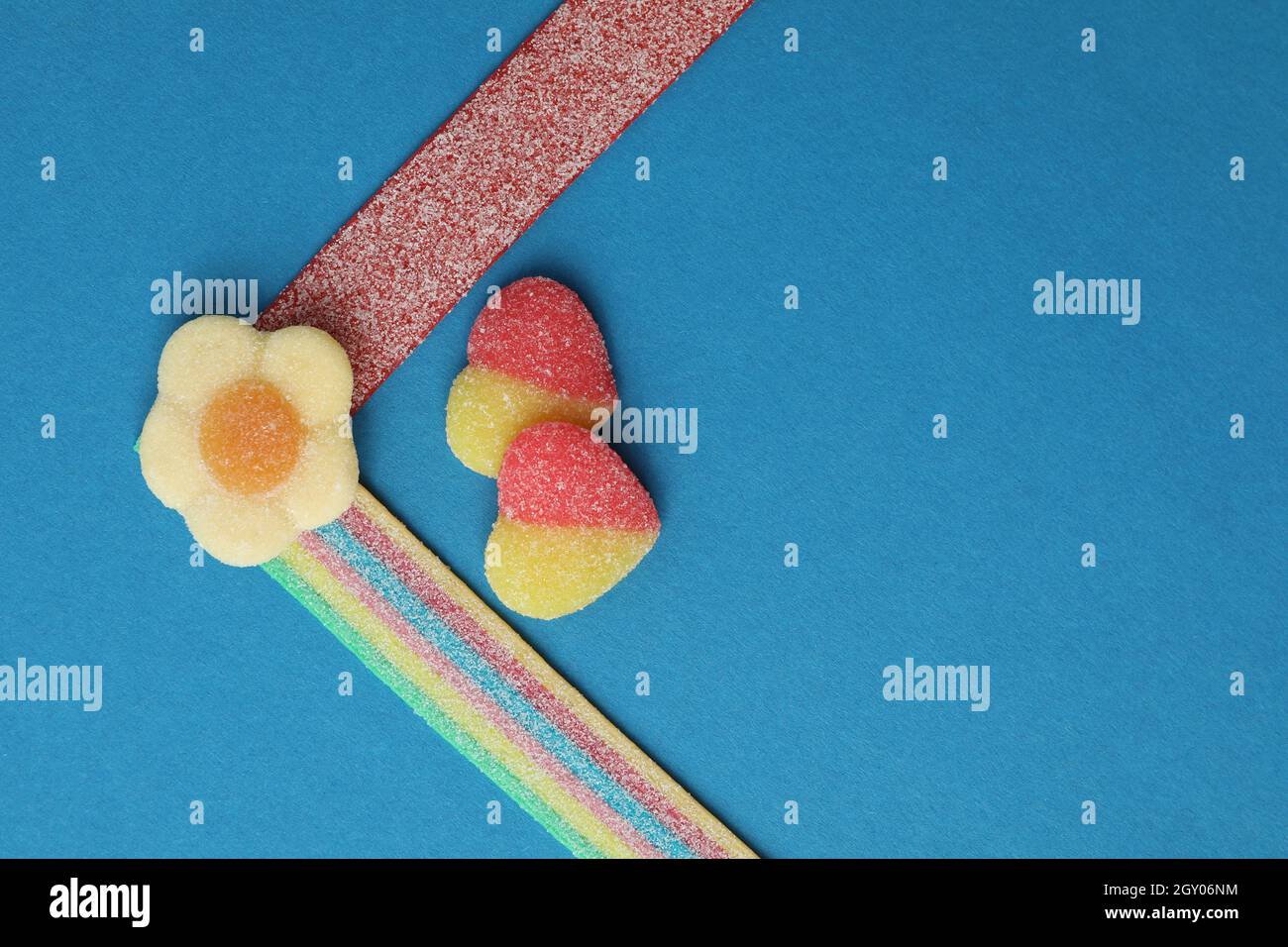 Gummy candies on blue background, space for text Stock Photo - Alamy