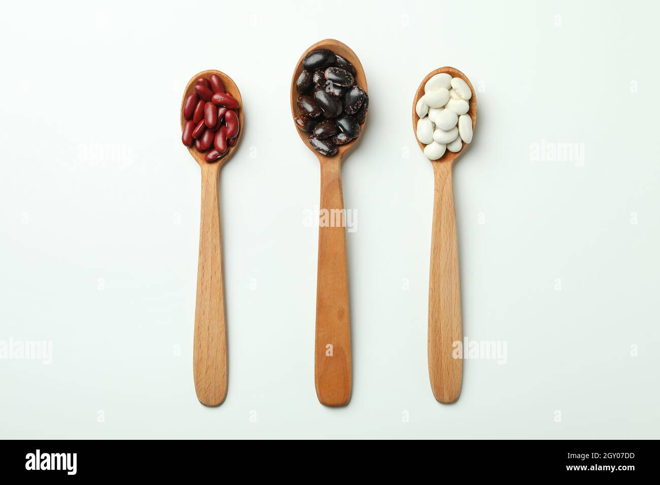 Spoons with different types of beans on white background Stock Photo ...