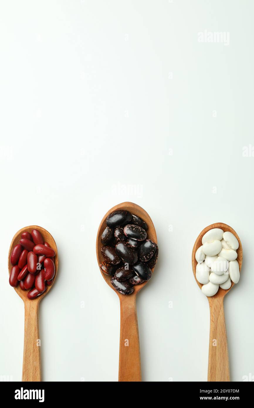 Spoons with different types of beans on white background Stock Photo ...