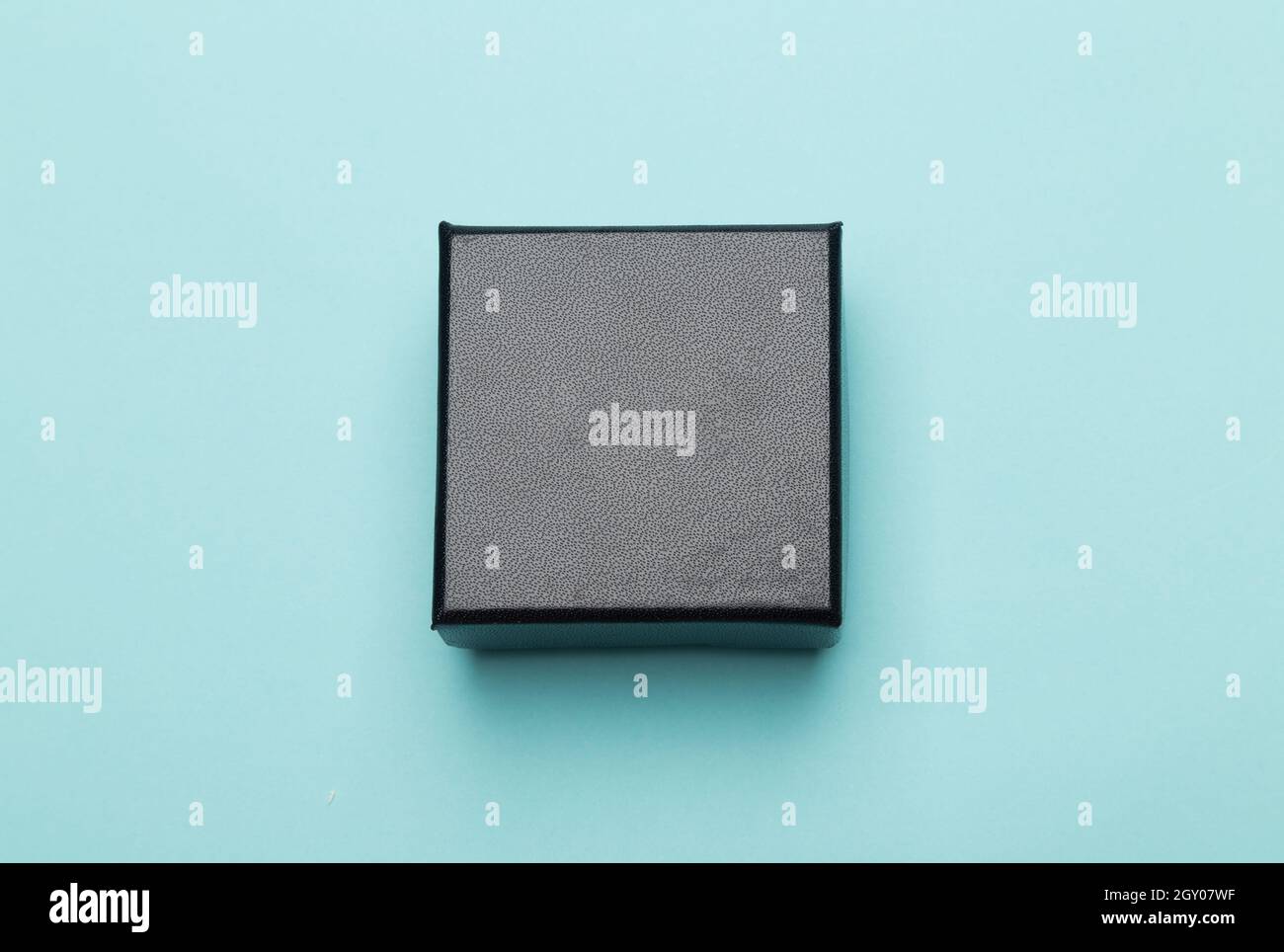 Mini black box product packaging isolated on blue background. Flat lay ...