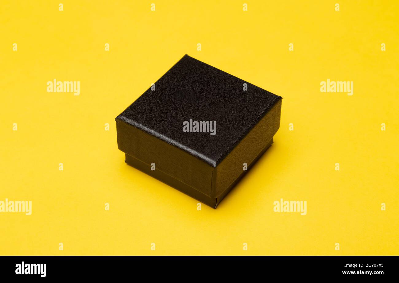 Mini black box product packaging isolated on yellow background Stock ...