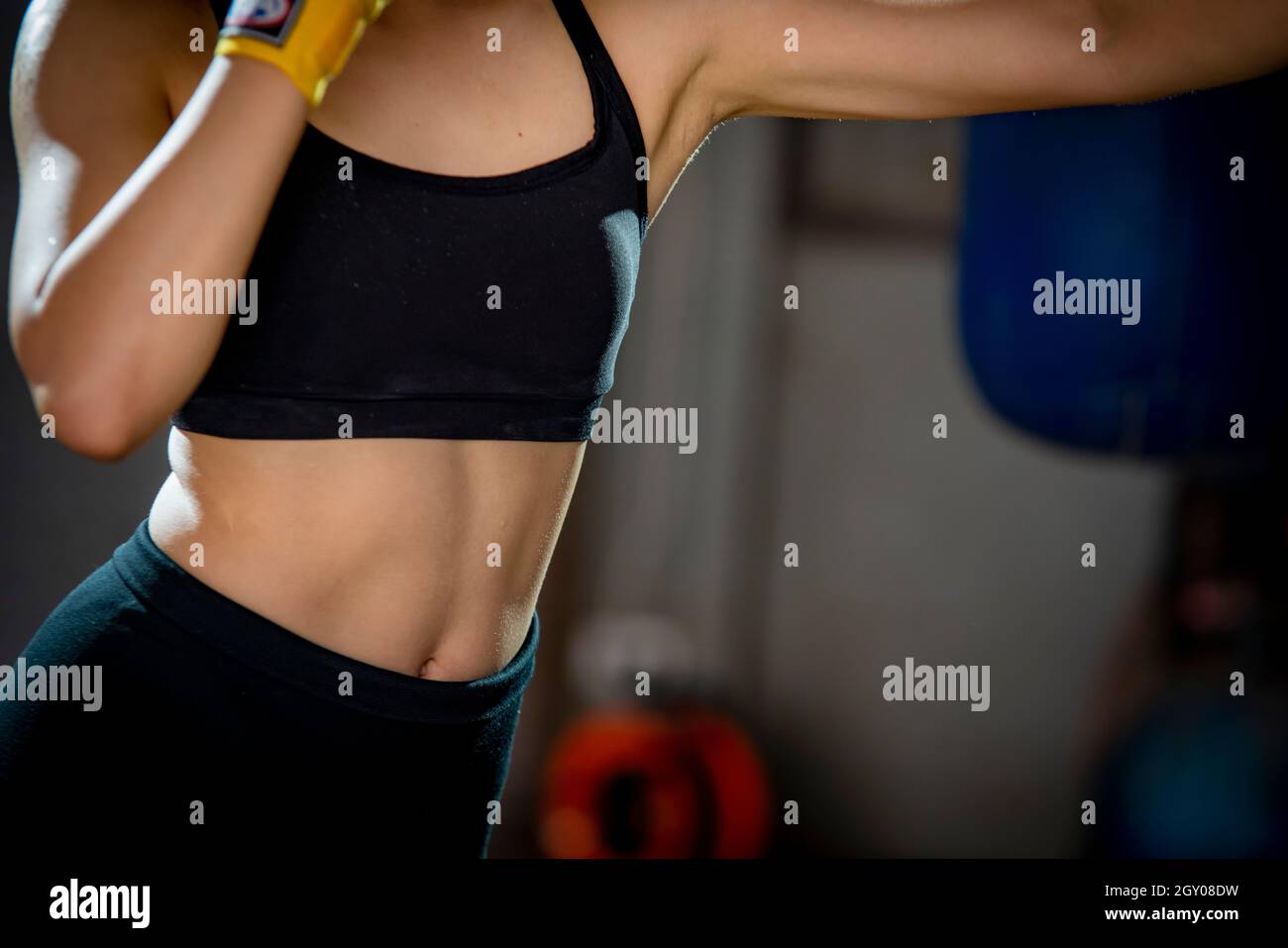 Woman boxer training hard.Girl wearing boxing gloves workout at gym ...