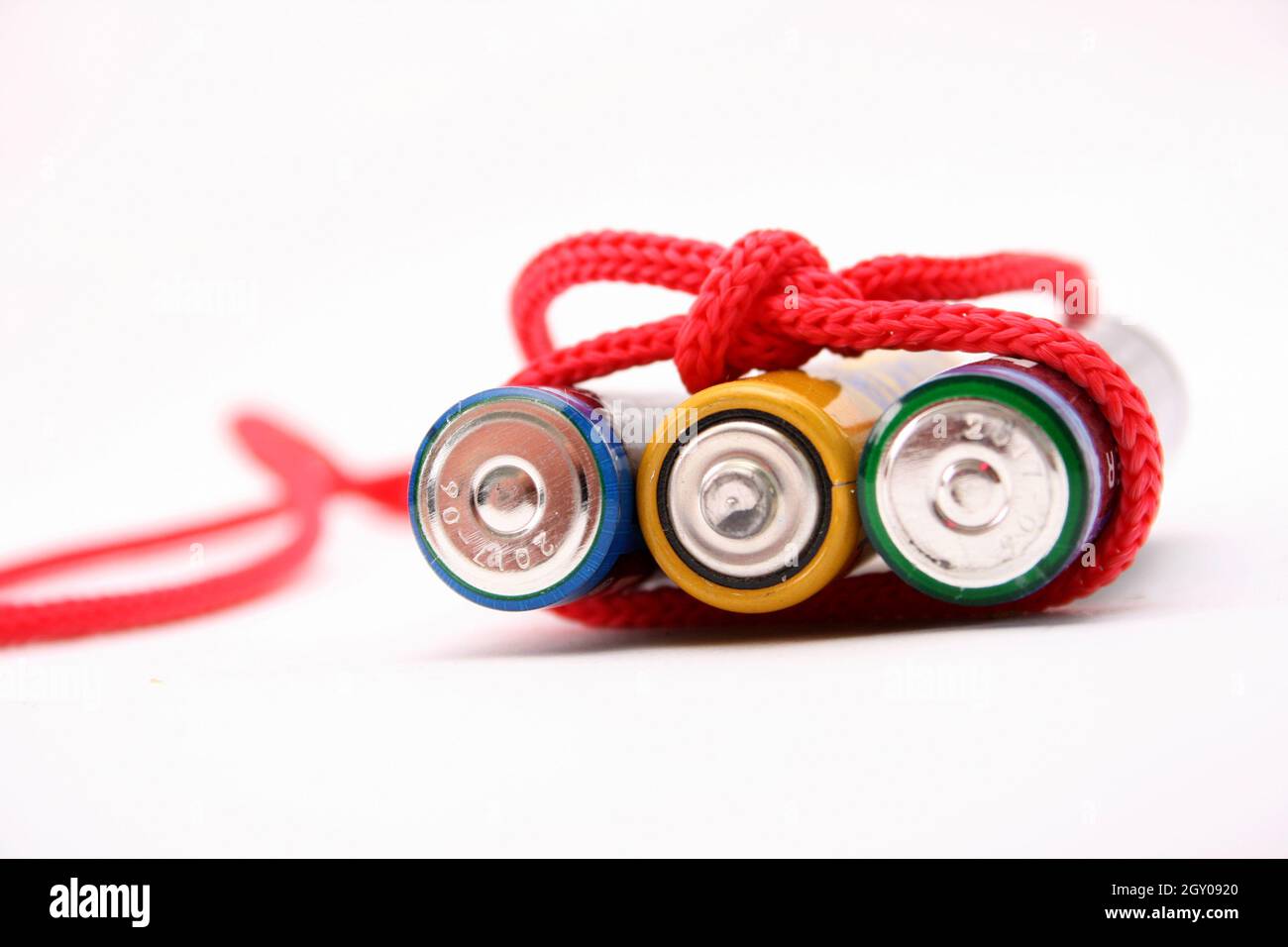 Battery bound with red rope. Energy concept Stock Photo - Alamy