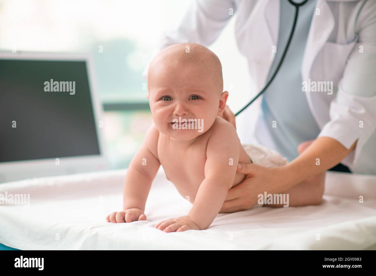 Scared infant looking at the camera during the medical exam Stock Photo ...