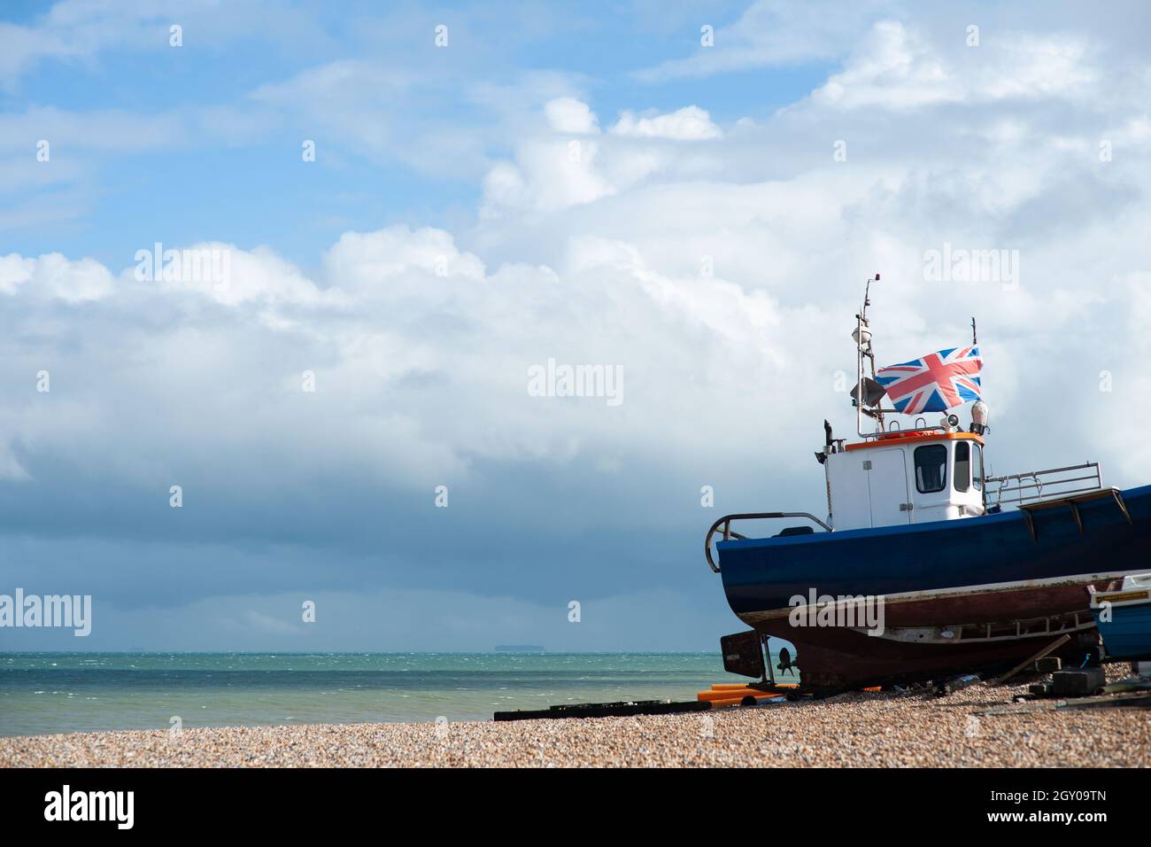 British fishing boat flying the Union Jack flag on the beach at Deal ...