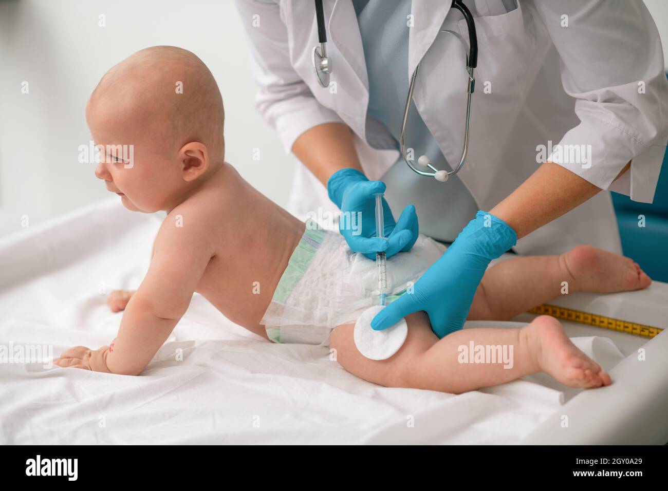 Tranquil cute neonate receiving an intramuscular injection Stock Photo ...