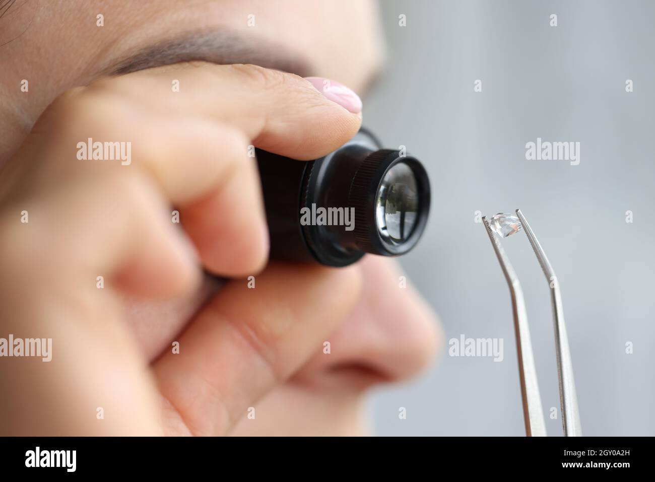 Woman looks through magnifying glass hi-res stock photography and ...