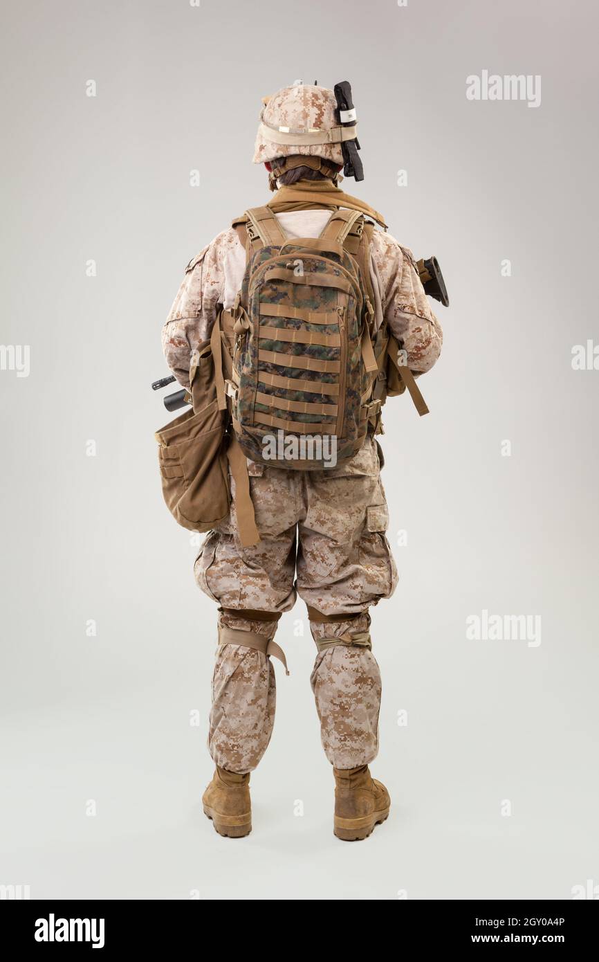 Portrait of a young American US Marine Corps soldier over grey ...