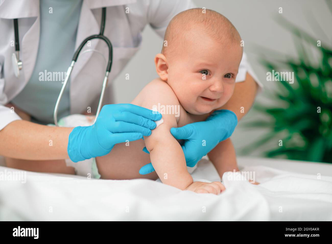 Scared baby being prepared for an upper arm injection Stock Photo - Alamy