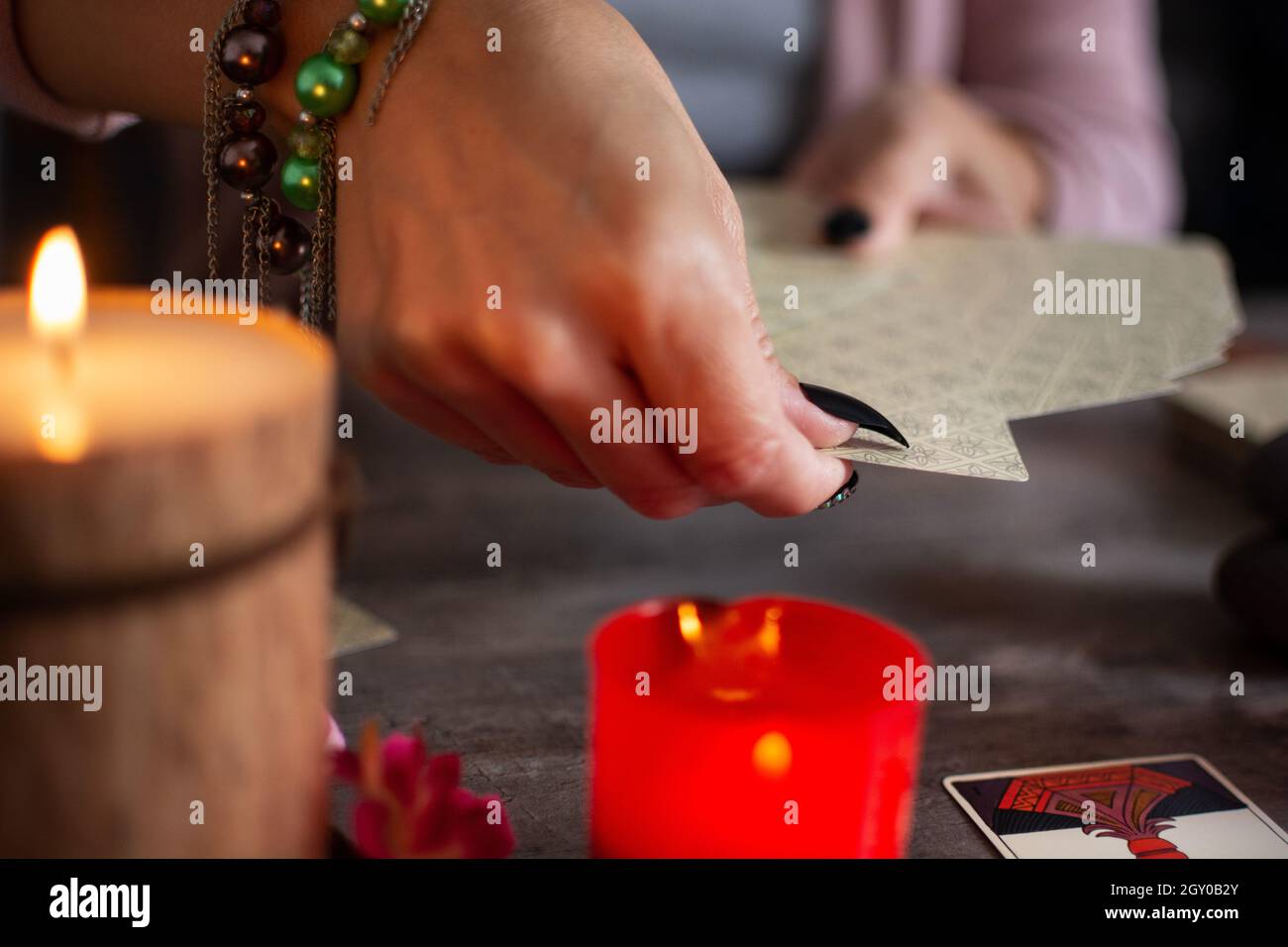 Fortune teller reading a future by tarot cards on rustic table Stock ...