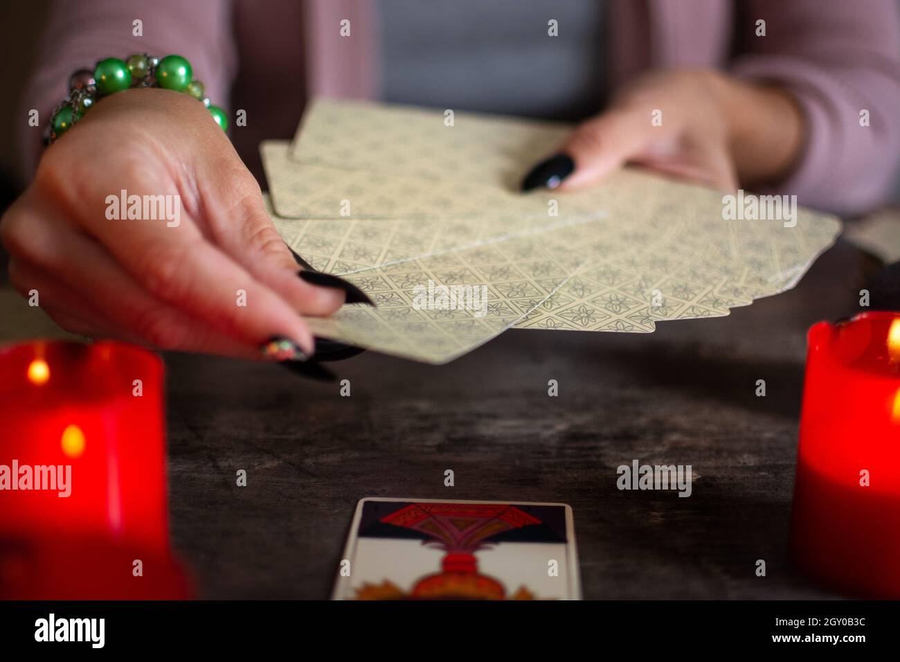 Fortune teller reading a future by tarot cards on rustic table Stock ...