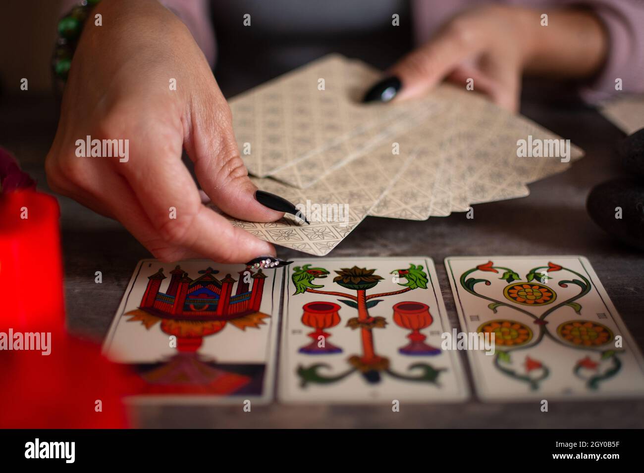 Fortune teller reading a future by tarot cards on rustic table Stock ...