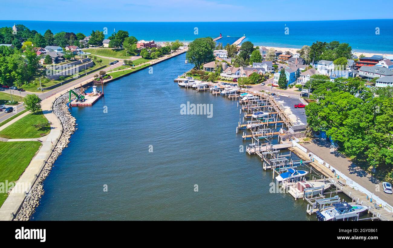 Aerial above of water canal river with dock, boats, and view of large ...