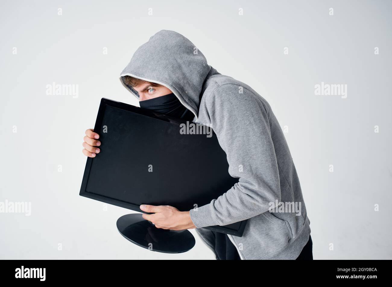 masked man hooded head hacking technology security light background Stock Photo - Alamy
