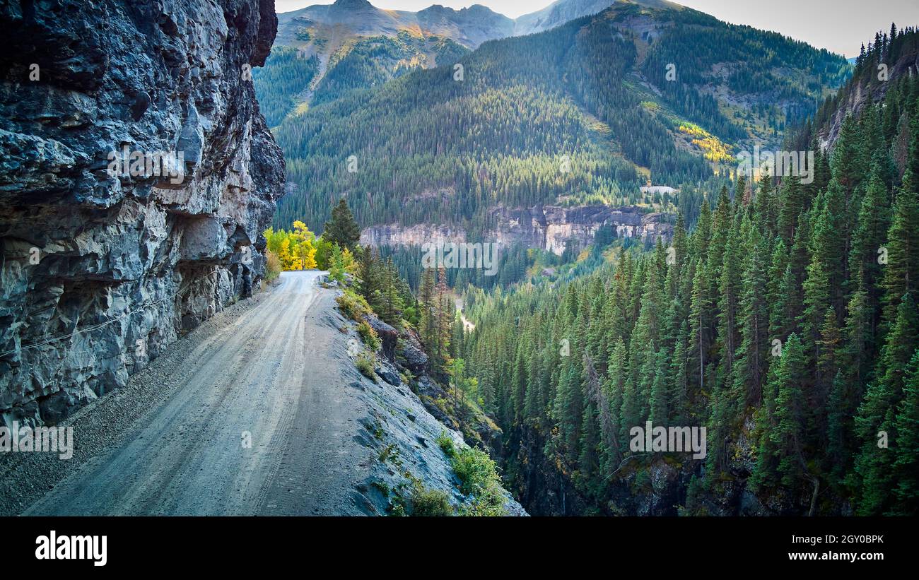 Dangerous dirt road in Rocky Mountains on narrow cliff edge in valley ...