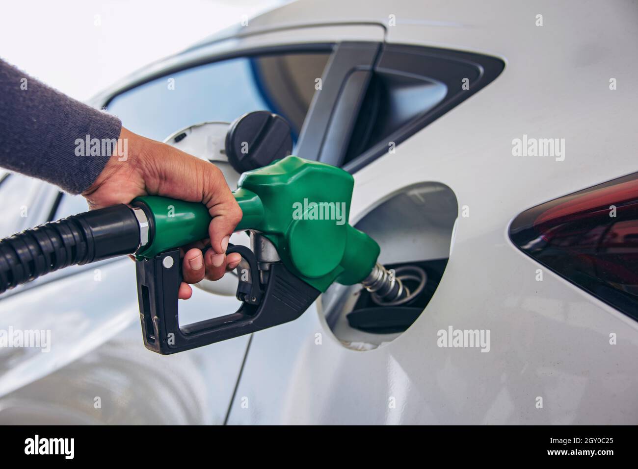 Man Handle pumping gasoline fuel nozzle to refuel. Vehicle fueling ...