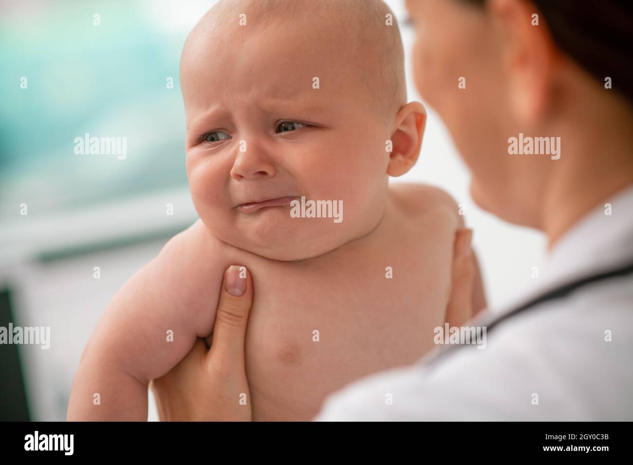 Scared neonate looking away during a medical exam Stock Photo - Alamy