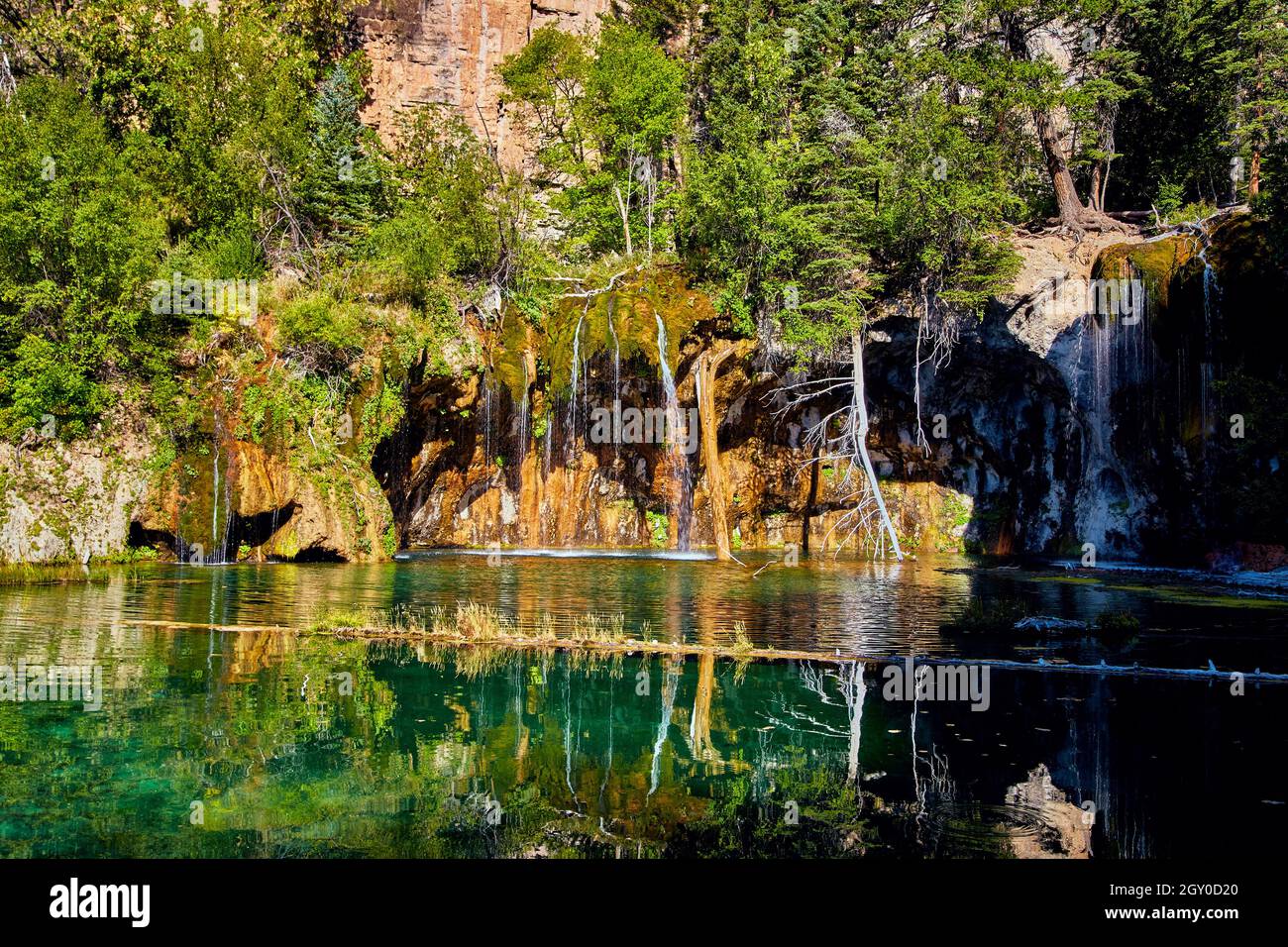 View of waterfalls over mossy rocks with teal water Stock Photo - Alamy