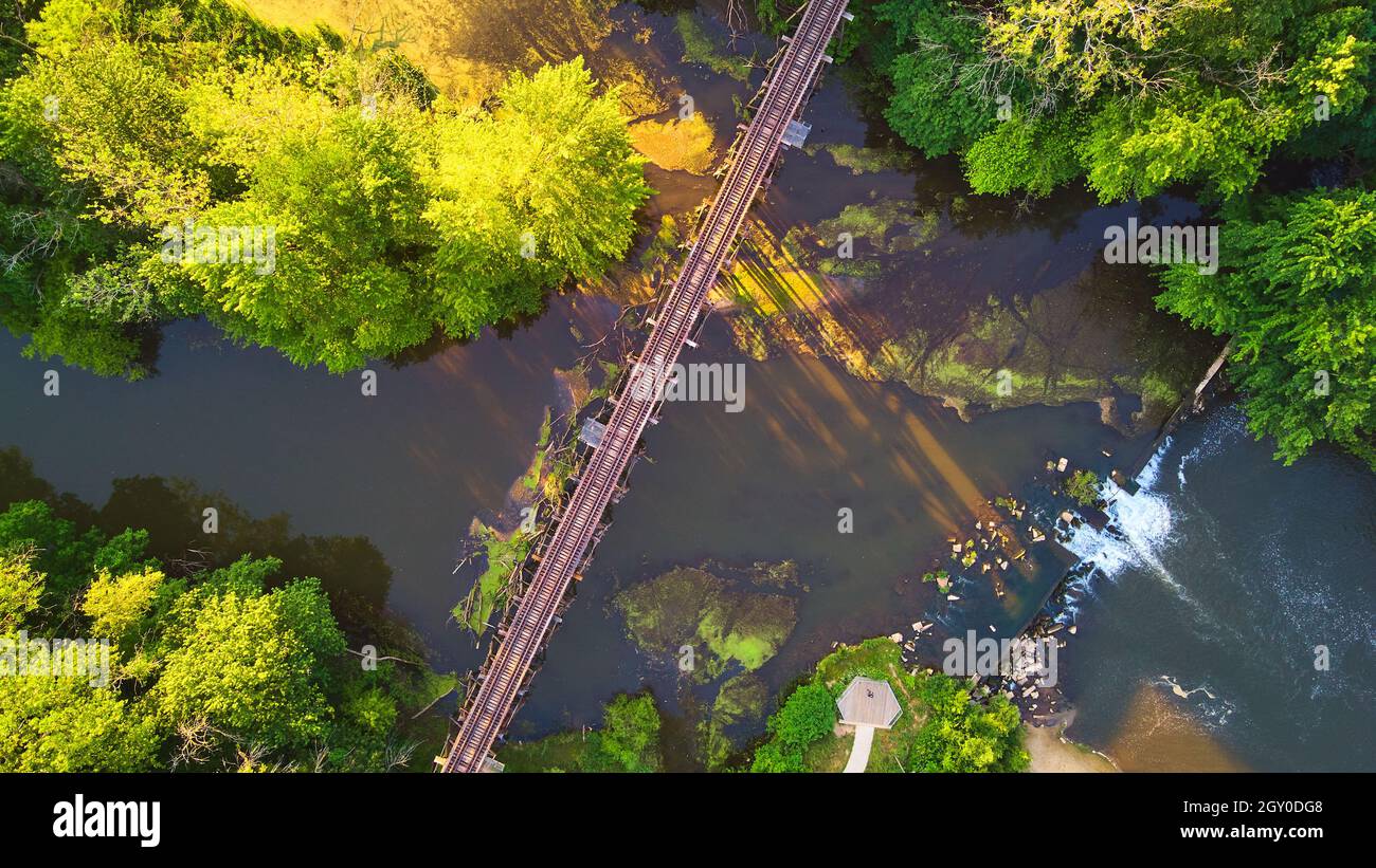 Aerial looking down at river and forest with manmade waterfalls from ...