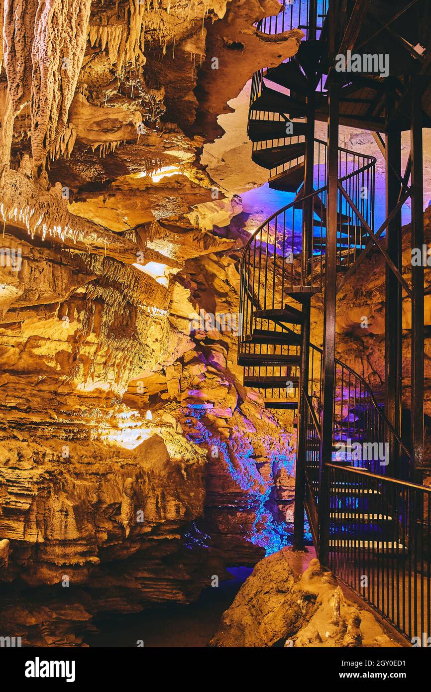 Spiral Staircase in underground cave with orange and blue lights Stock ...