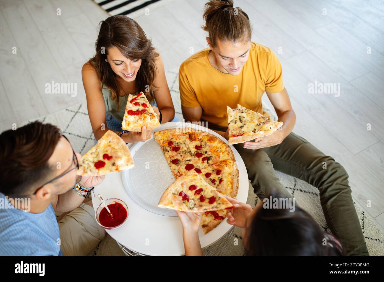 Spending time with friends. Group of cheerful young people talking and ...