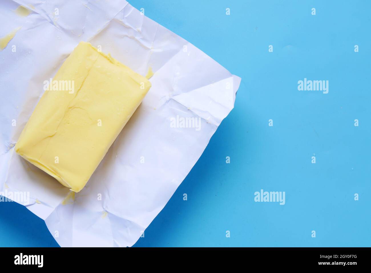 slice of a butter on a paper on table Stock Photo - Alamy