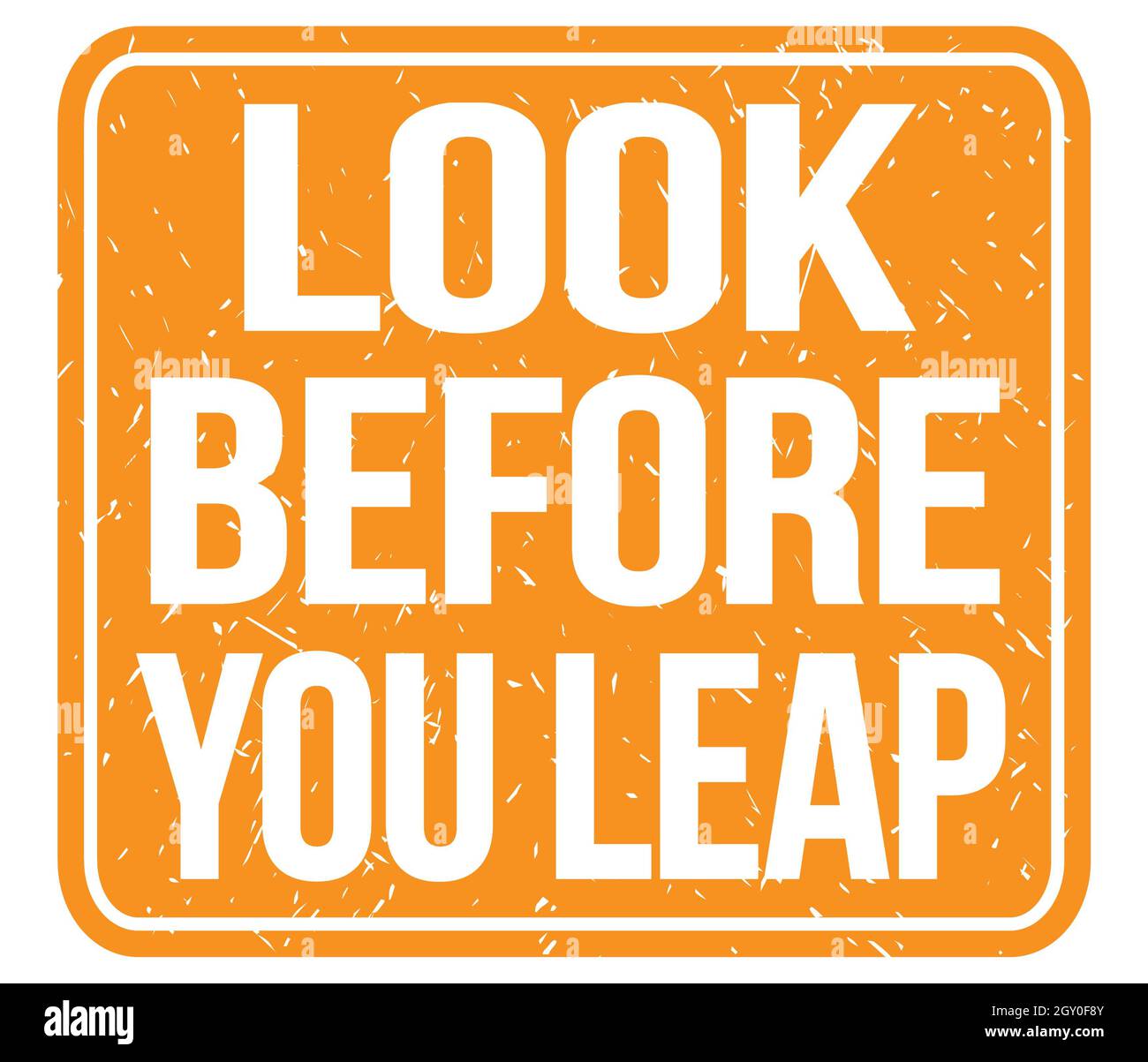 LOOK BEFORE YOU LEAP, text written on orange vintage stamp sign Stock ...