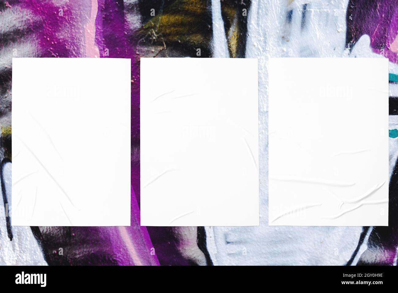 colorful urban wall texture with three wrinkled glued poster templates ...