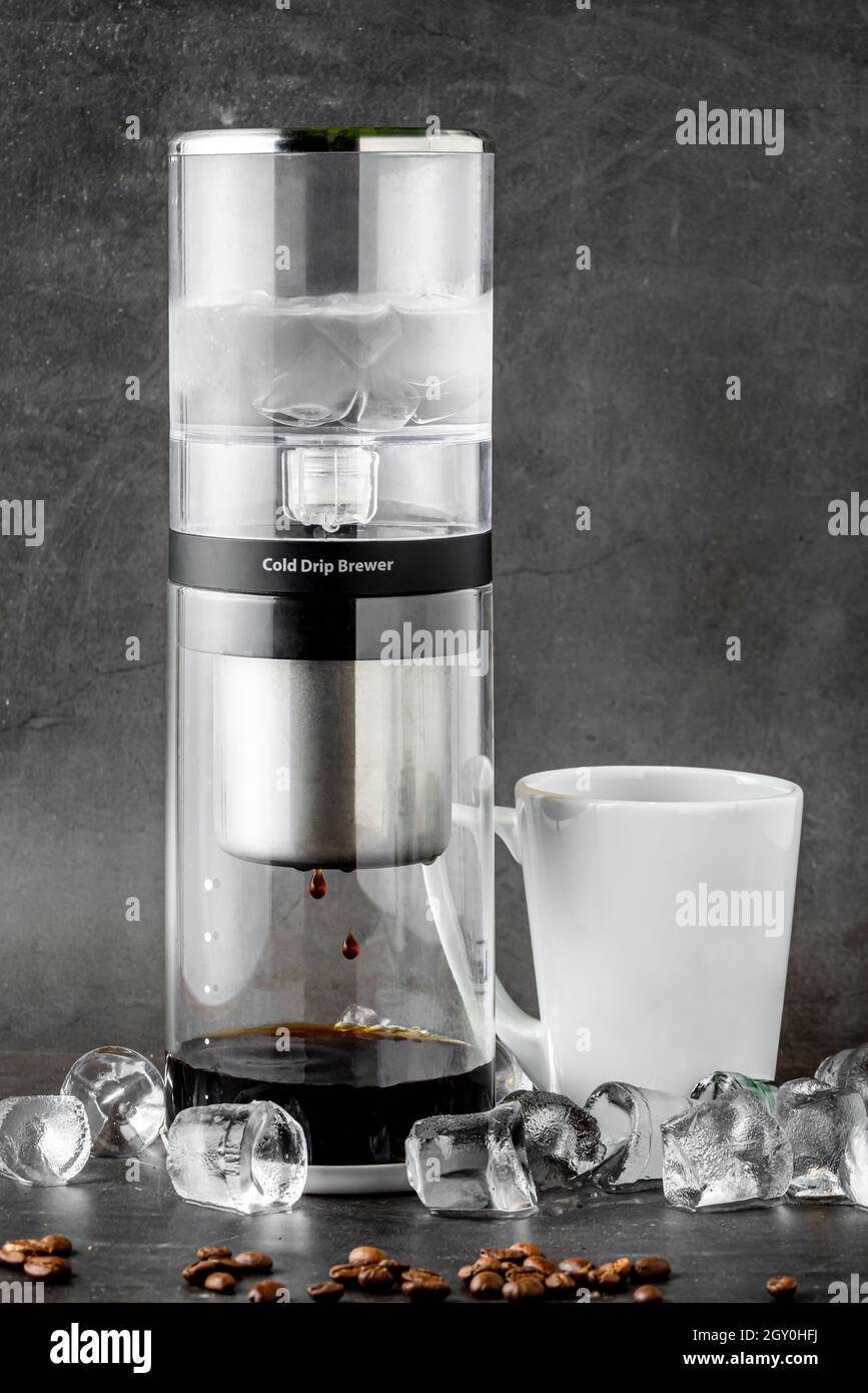 Modern Cold brew drip tower coffee maker on dark stone background Stock ...