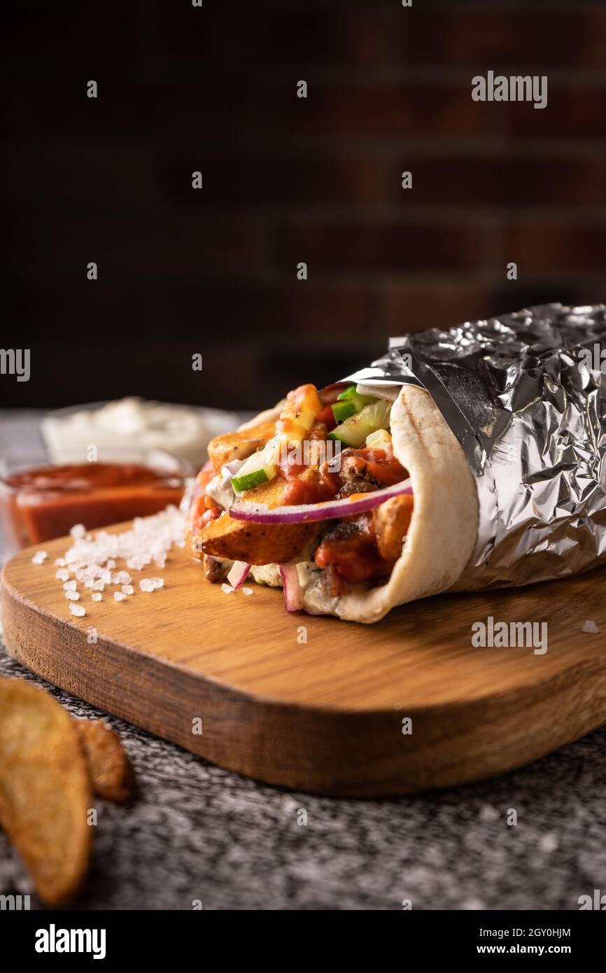 doner kebab, a shawarma in a pit of fresh vegetables and meat. with ...