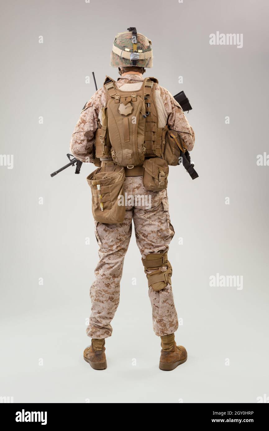 Rear view of military soldier US army marines operator studio shot ...