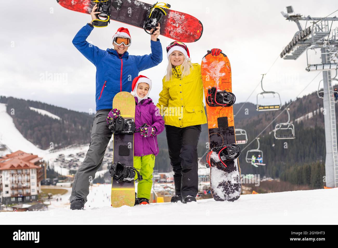 Parents with daughter celebrating winter holidays. family in santa hat ...