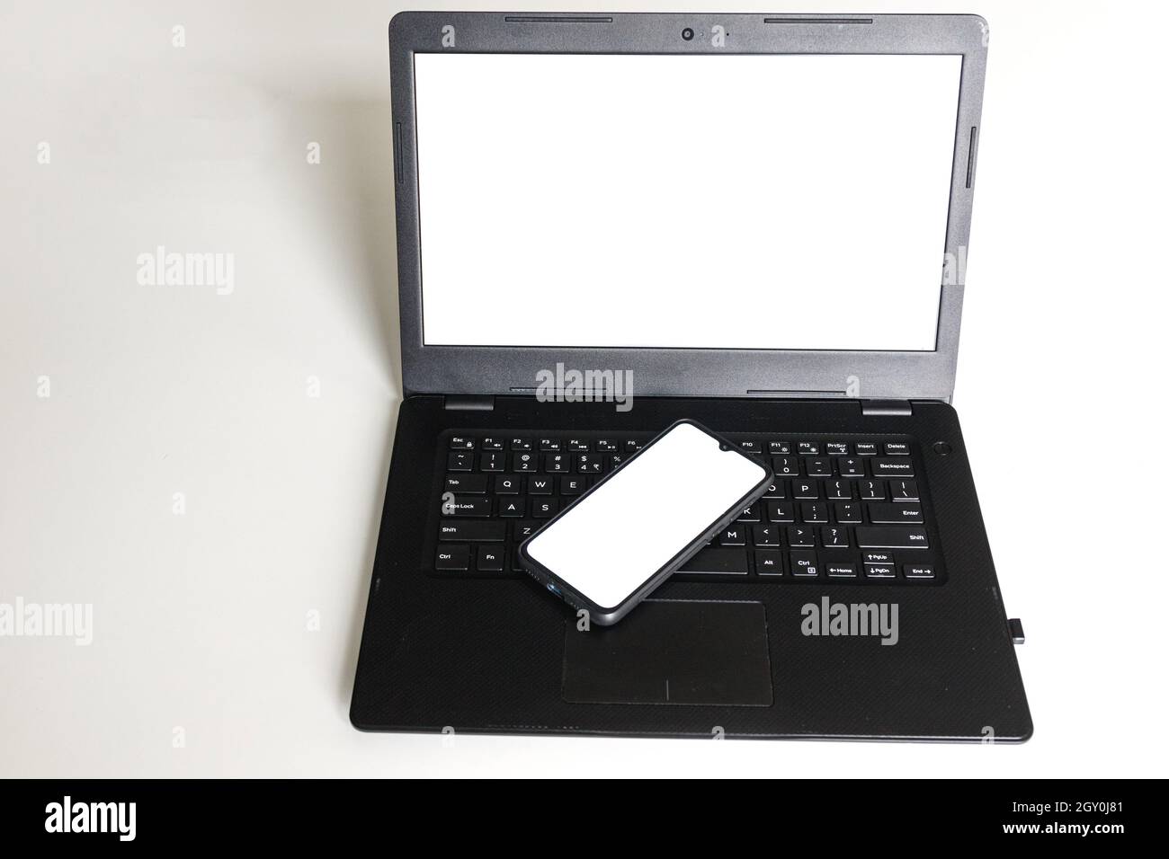 Empty white screen smartphone and laptop for mockup. Mobile phone and ...