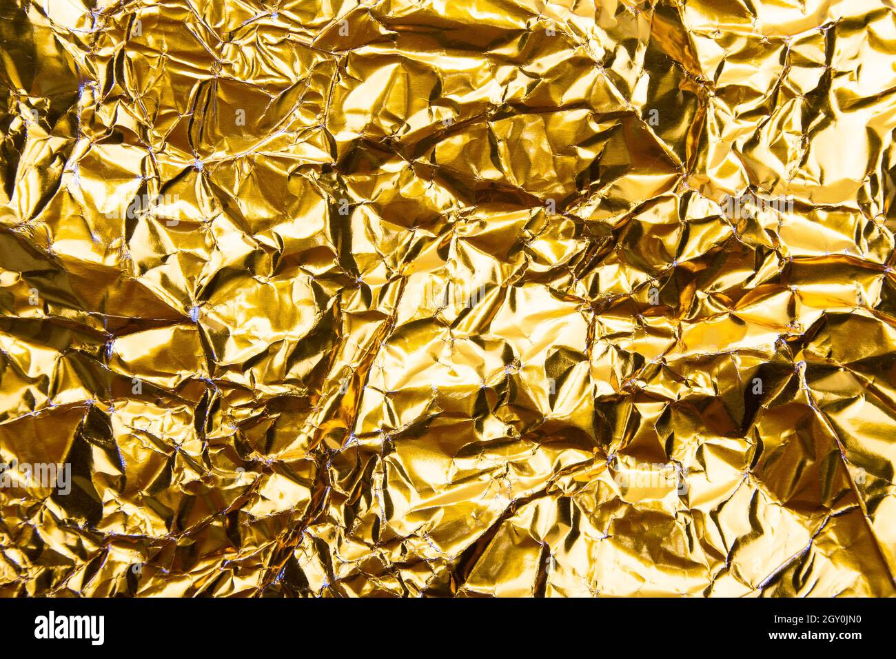 Gold crumpled foil paper texture background Stock Photo - Alamy