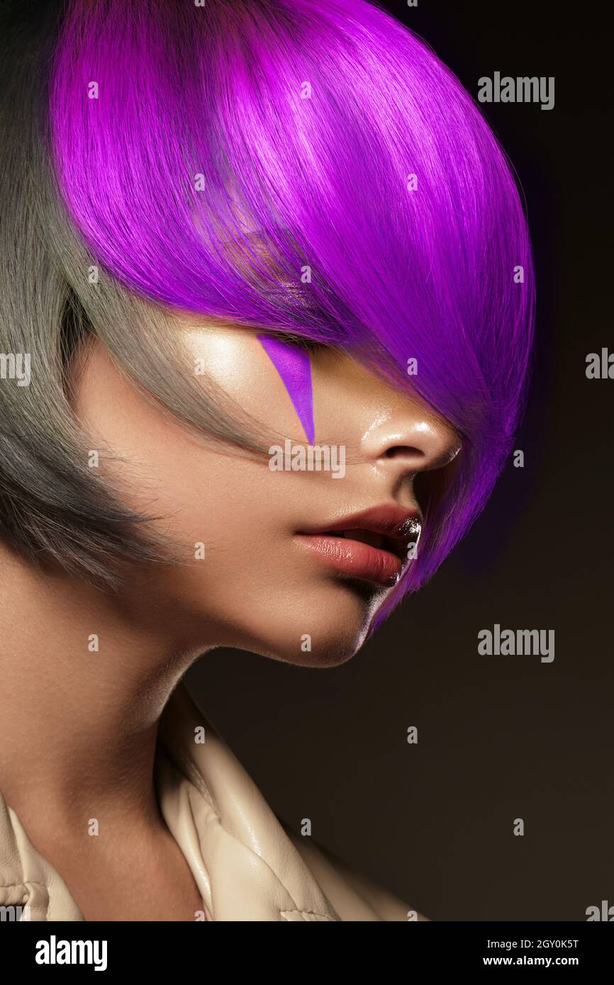 Beautiful woman with multi-colored hair and creative make up and ...