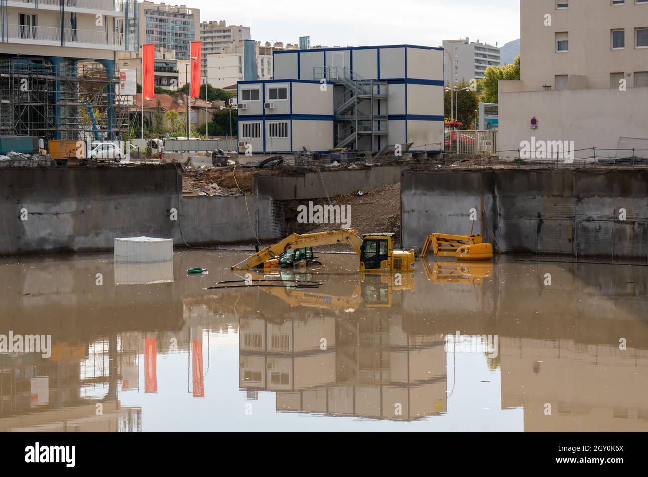 Construction site: construction machinery flooded due to heavy rain ...