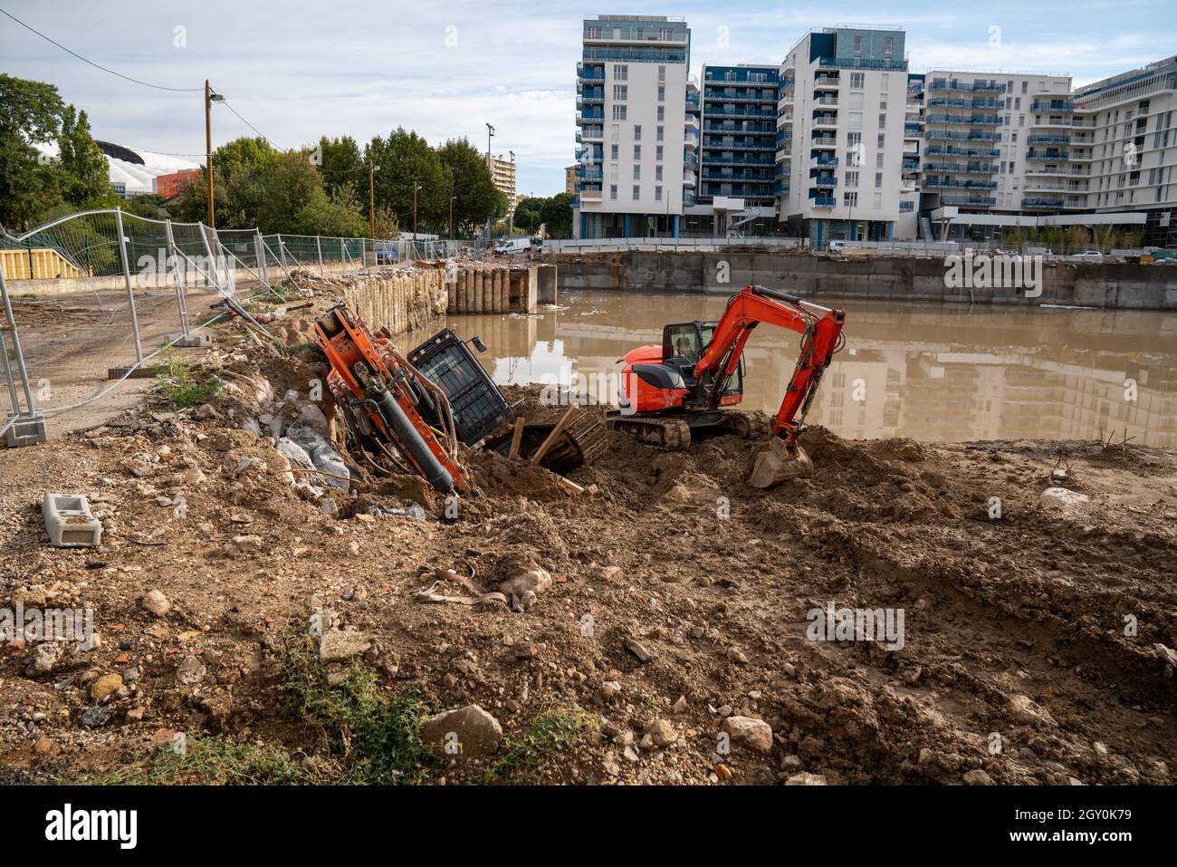 Construction site: construction machinery flooded due to heavy rain ...