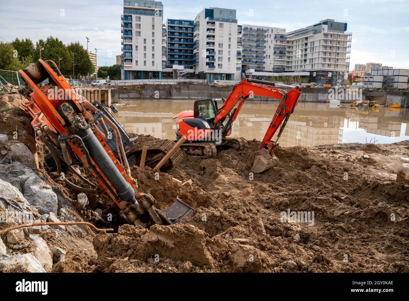 Construction site: construction machinery flooded due to heavy rain ...