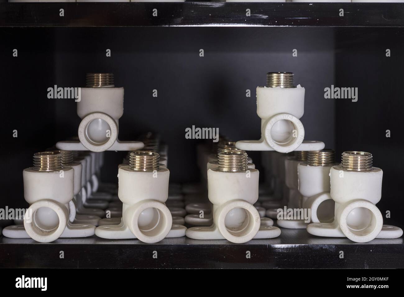 Set of polypropylene, plastic corners for connecting pipes on a white ...