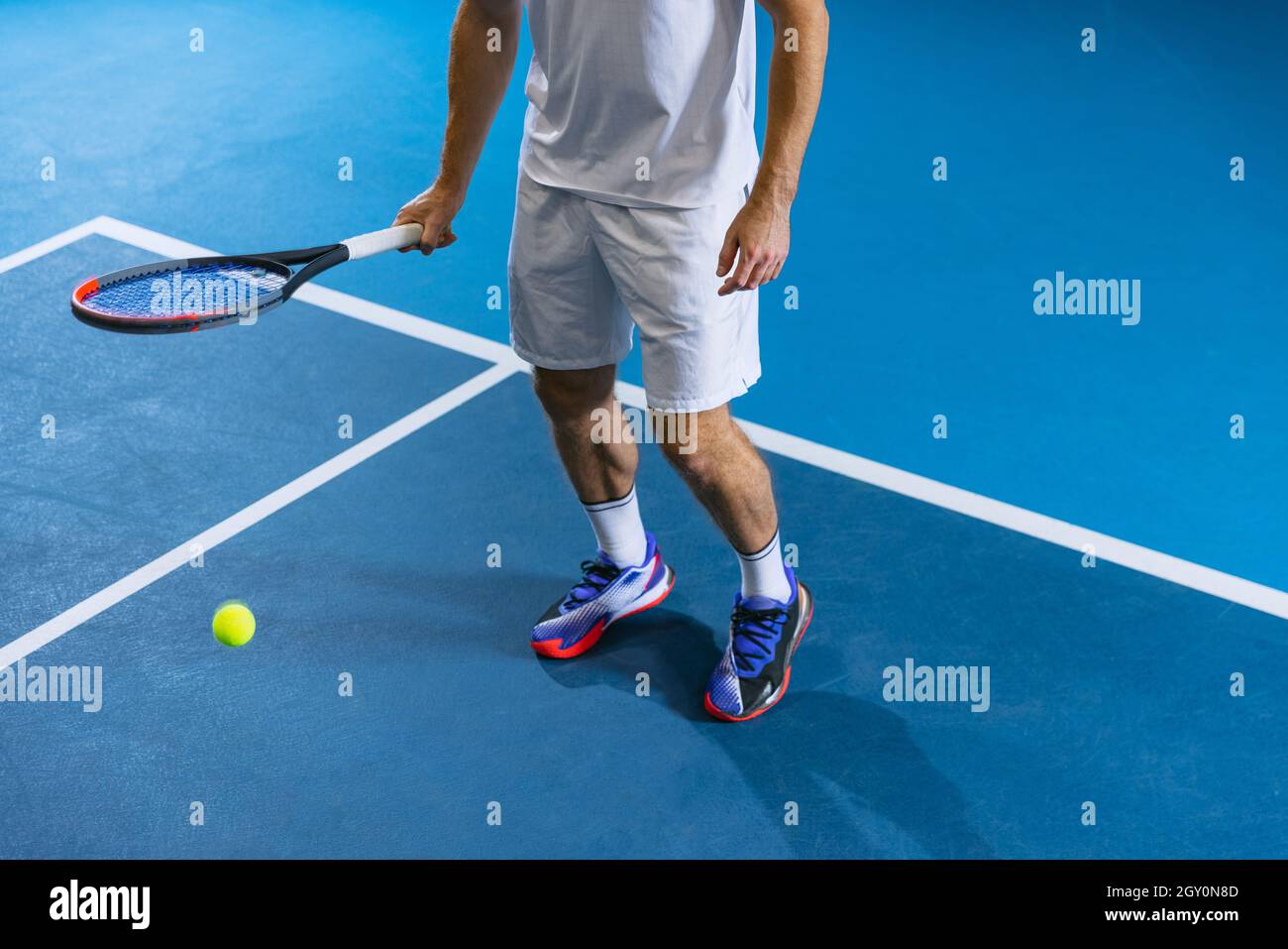Top view half image of male tennis player in motion holding tennis ...