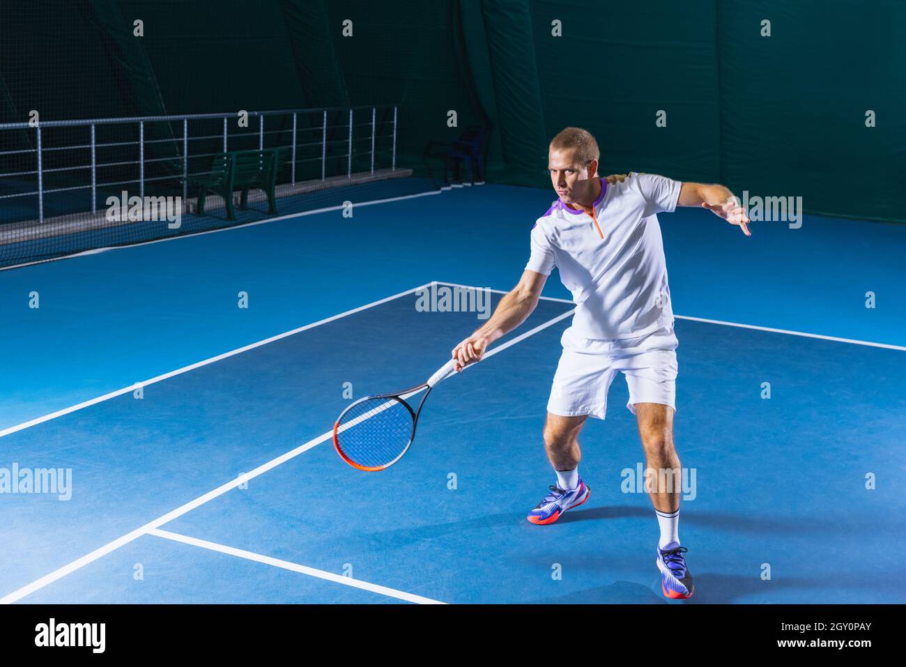 Full-length portrait of professional tenis player, man training over ...