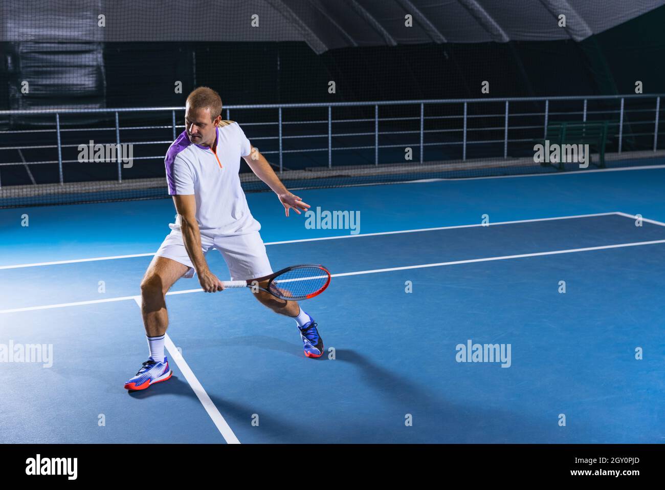 Full-length portrait of professional tenis player, man training over ...