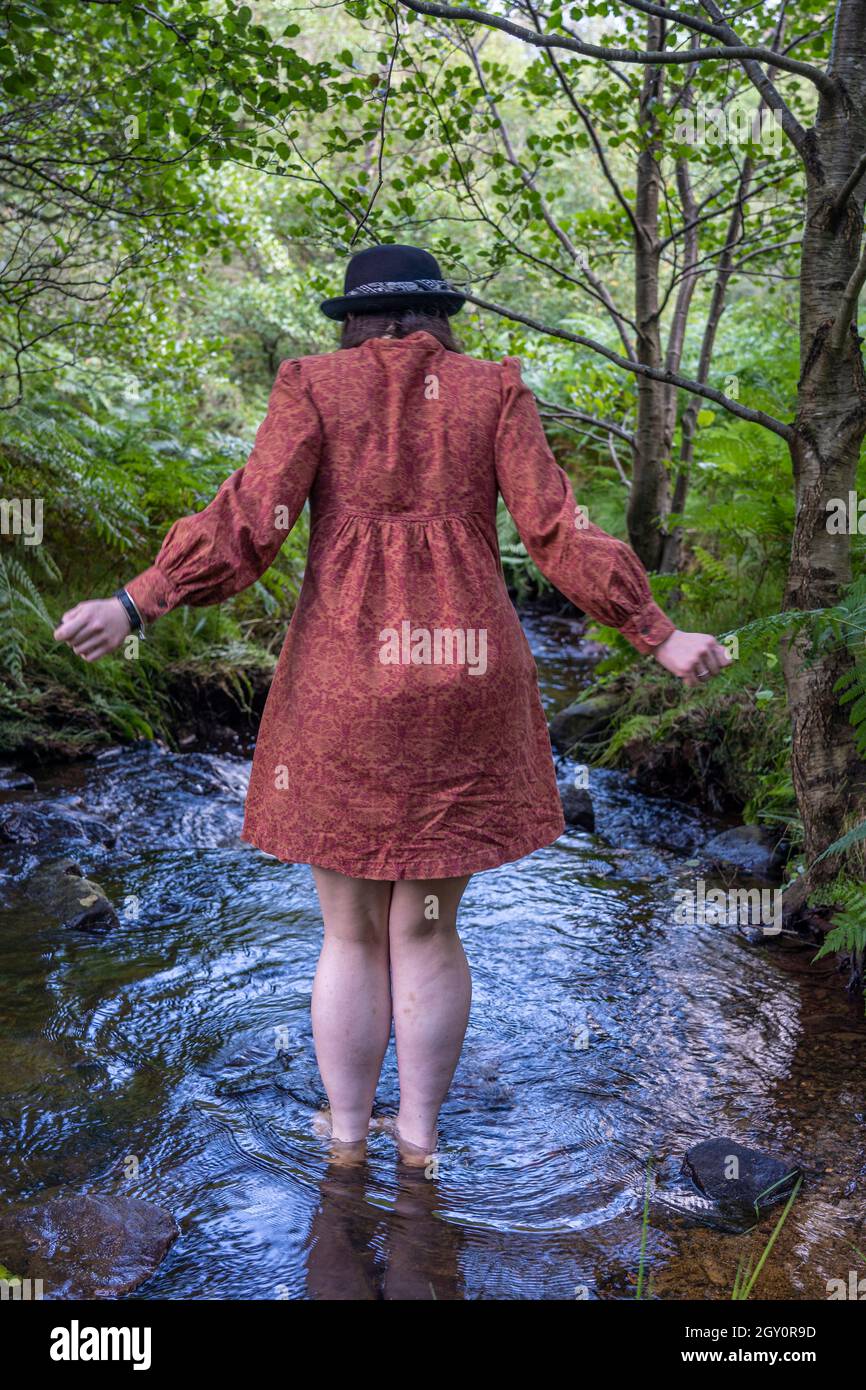 girl standing in small stream looking away Stock Photo - Alamy