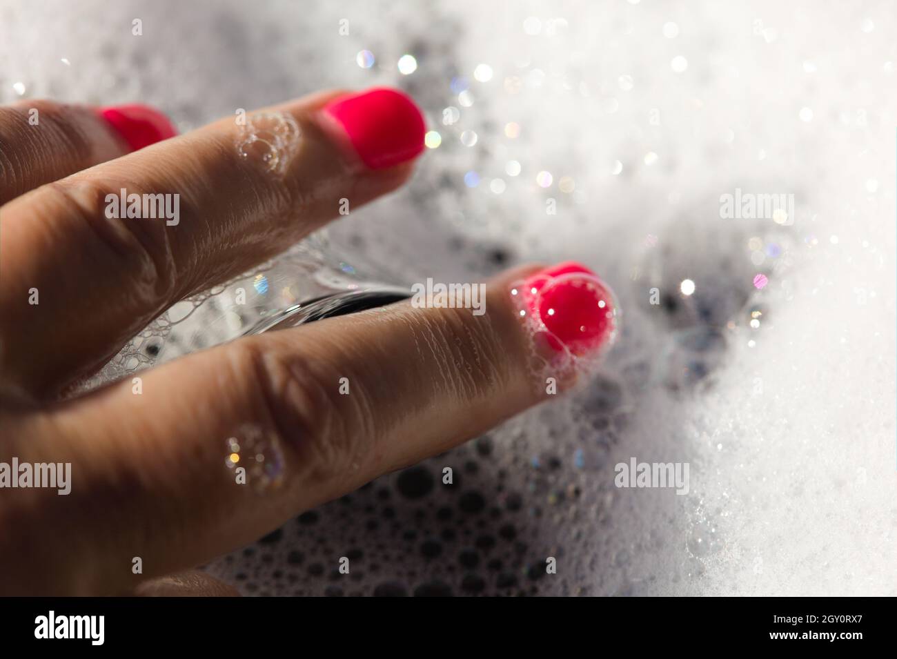Hand in washing up with Soap suds Stock Photo - Alamy