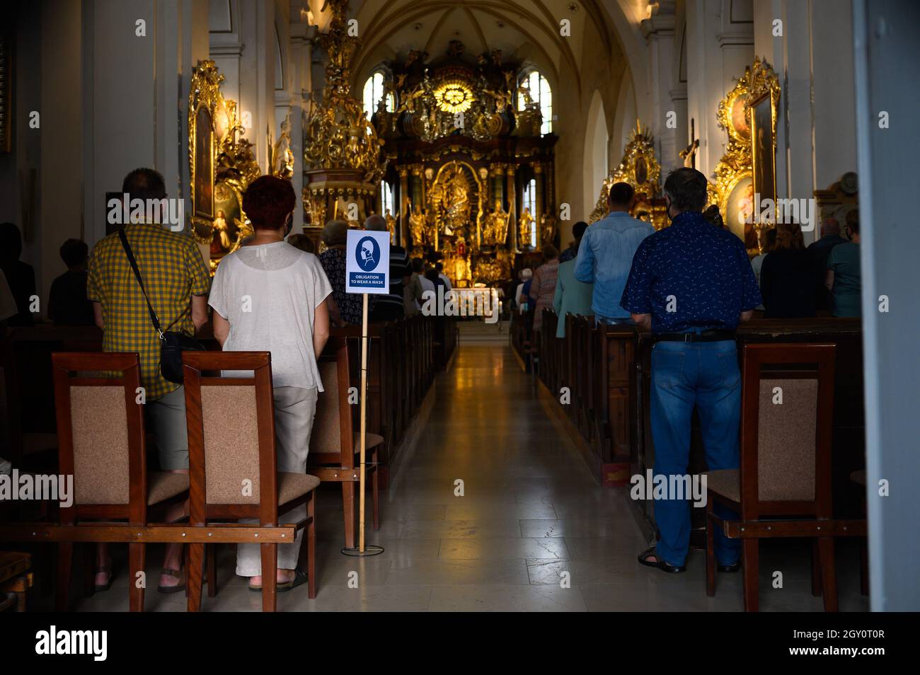 Board with information about obligation to wear a mask in the church ...