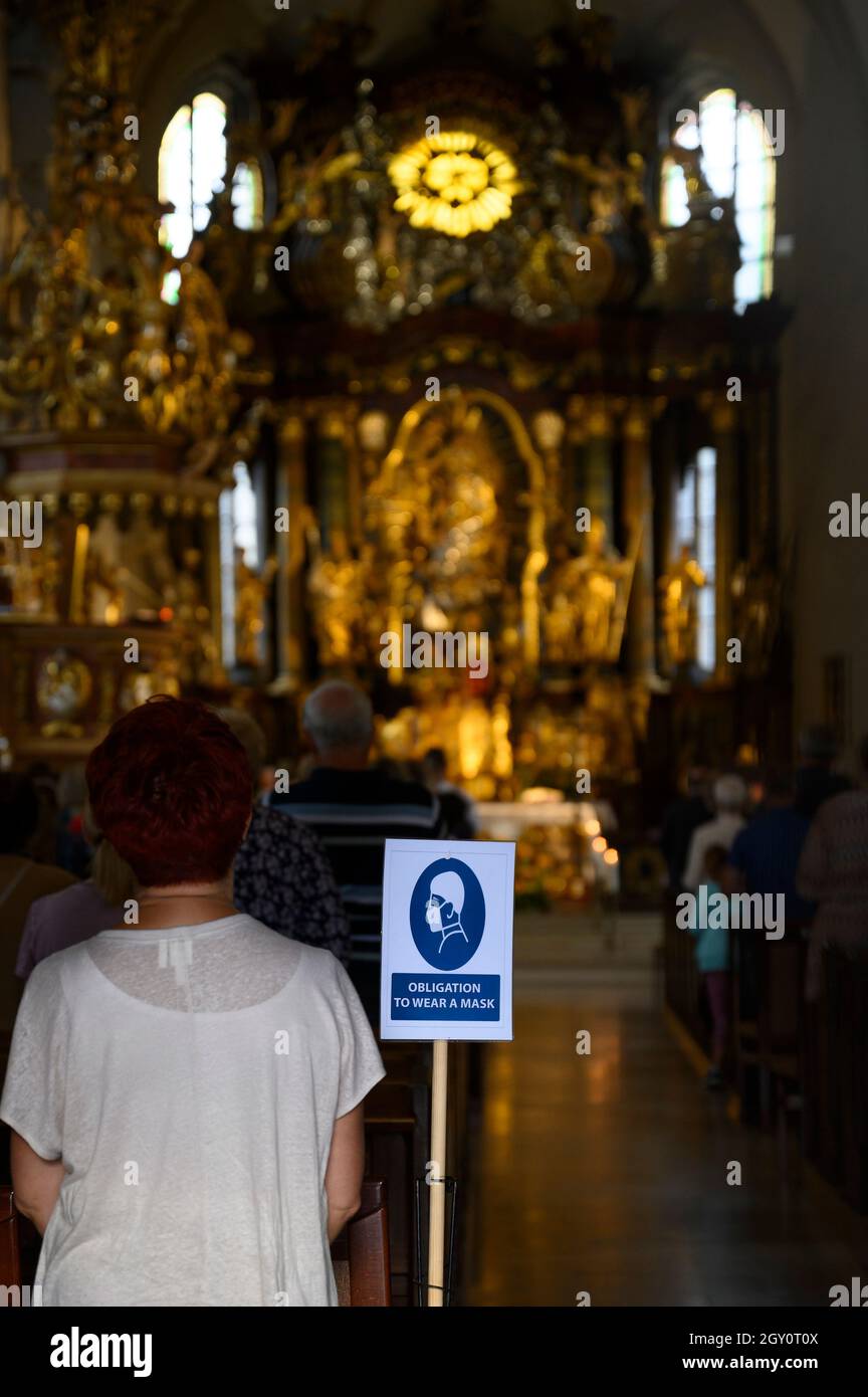 Board with information about obligation to wear a mask in the church ...