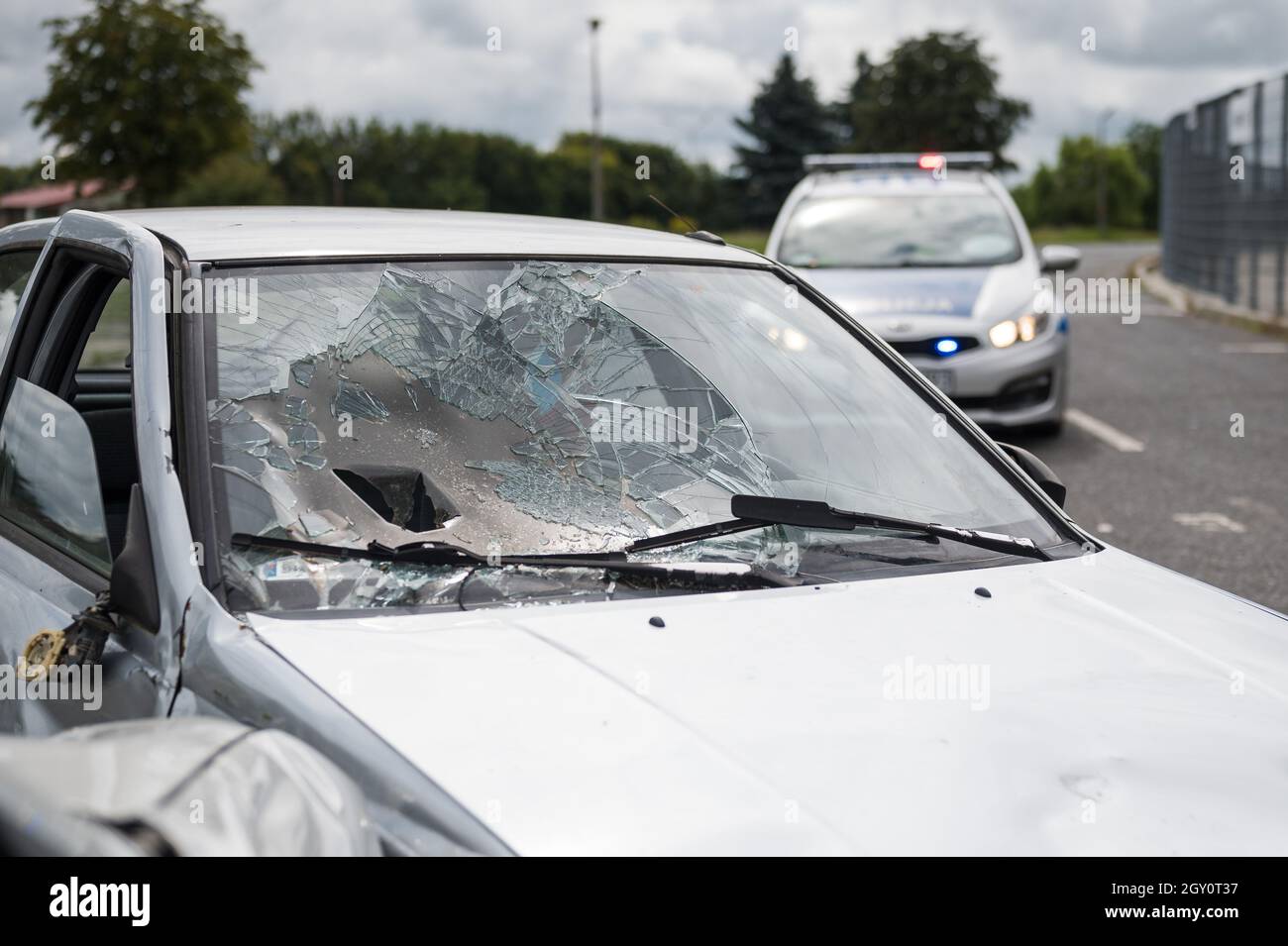 The car destroyed in an accident and in the background a police car on ...