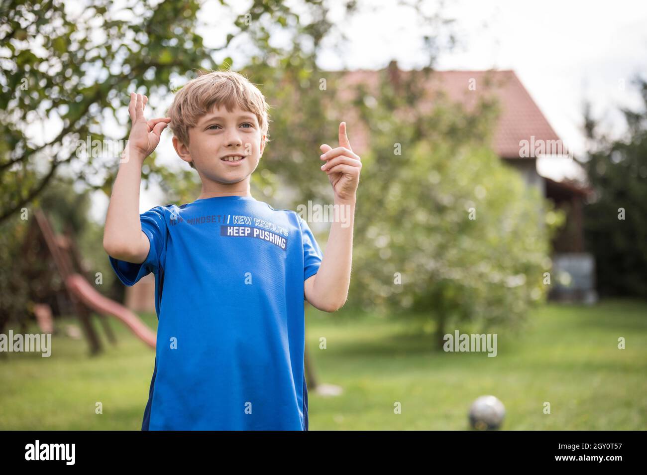 Portrait of the excaiting cute 9 years old boy with summer sunlight on ...