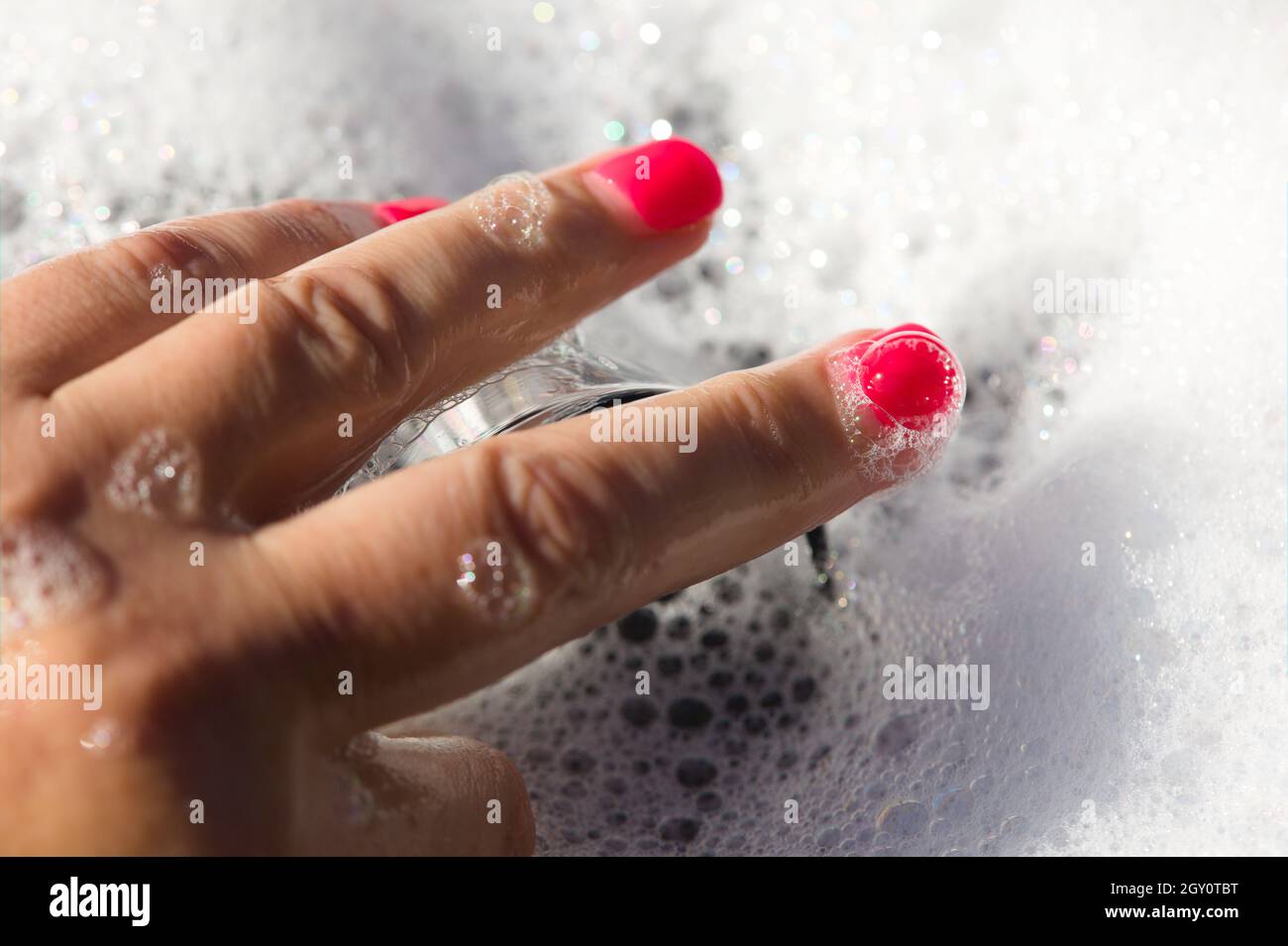 Hand in washing up with soap suds Stock Photo - Alamy
