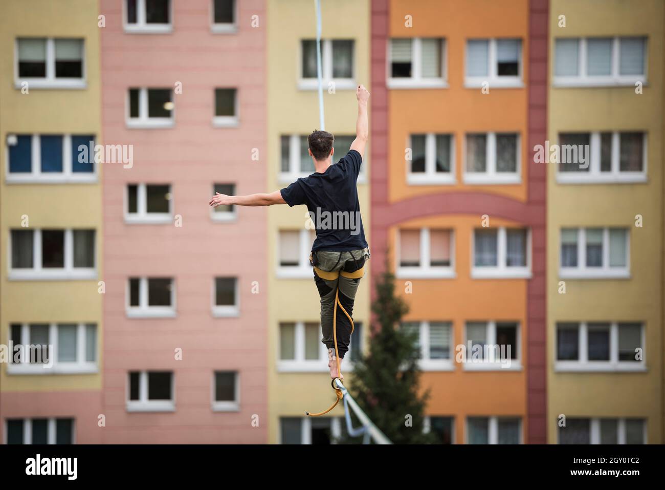 A tightrope walker is walking on the rope at a high altitude Stock ...